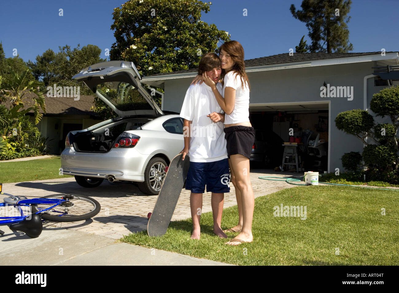 Teenagers goofing off in front yard Stock Photo - Alamy