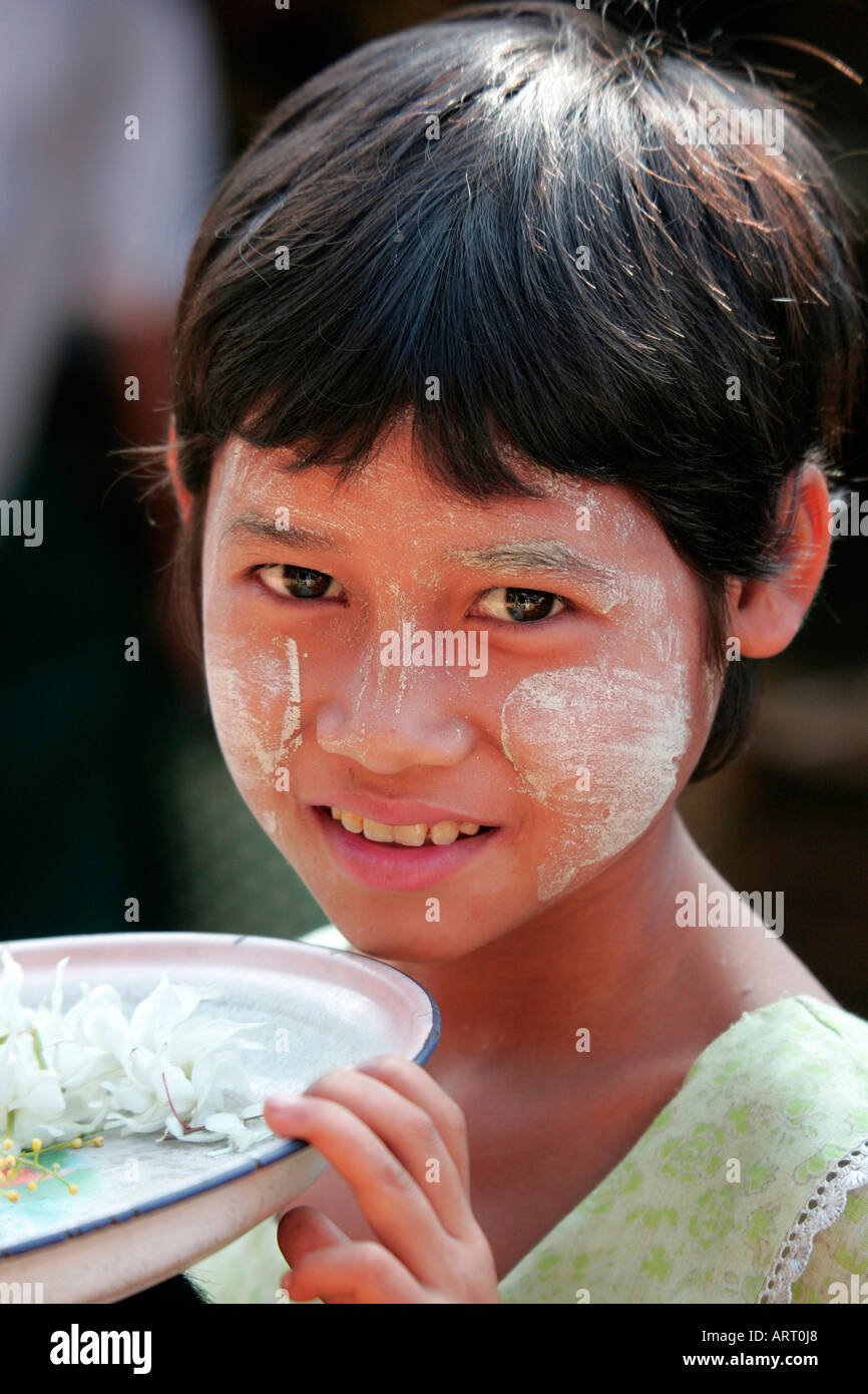 Portait of a Burmese girl wearing thanakha at the market at Kyaiktiyo ...