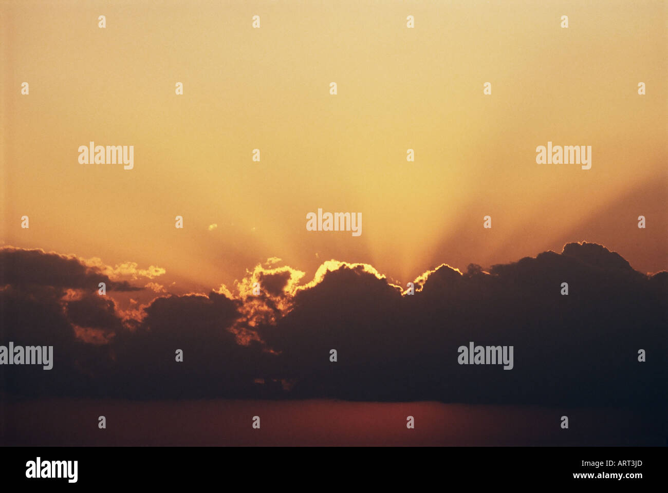 Sun through clouds Stock Photo - Alamy