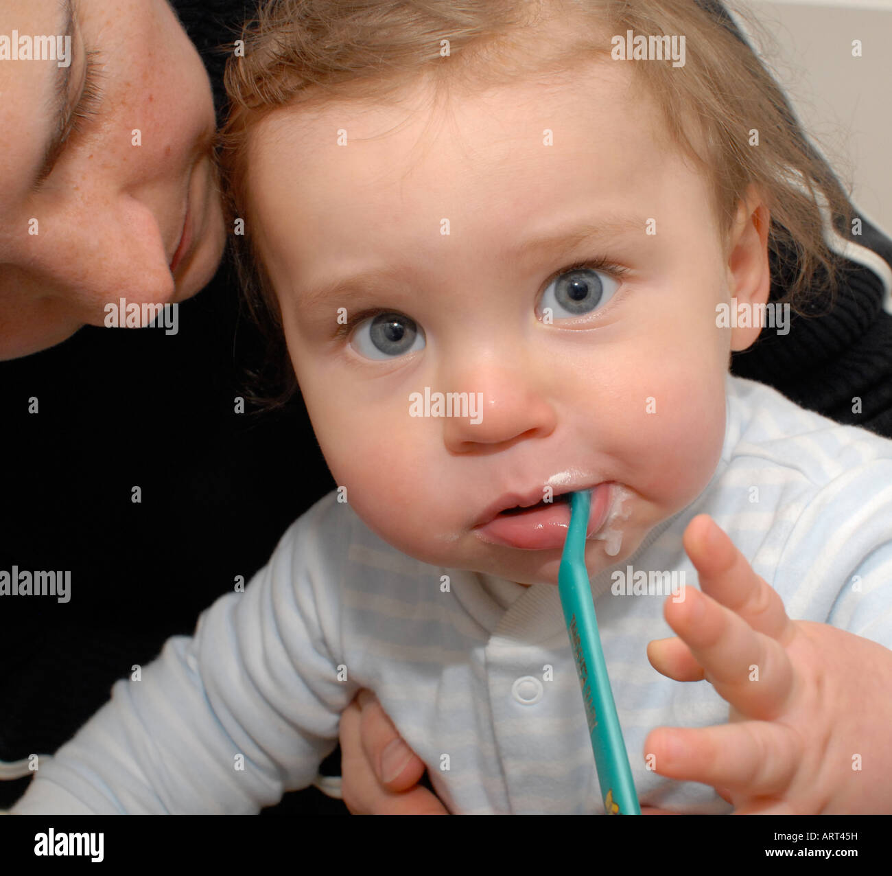 Baby learning to clean his teeth Stock Photo - Alamy