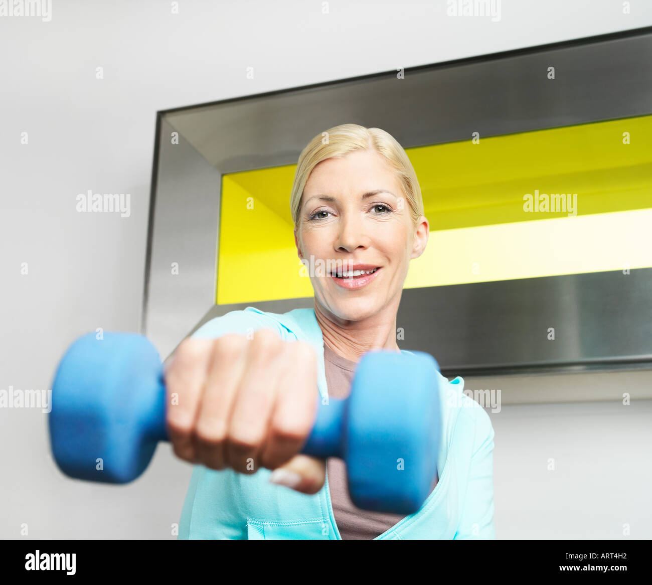 Woman weightlifting in health club Stock Photo - Alamy