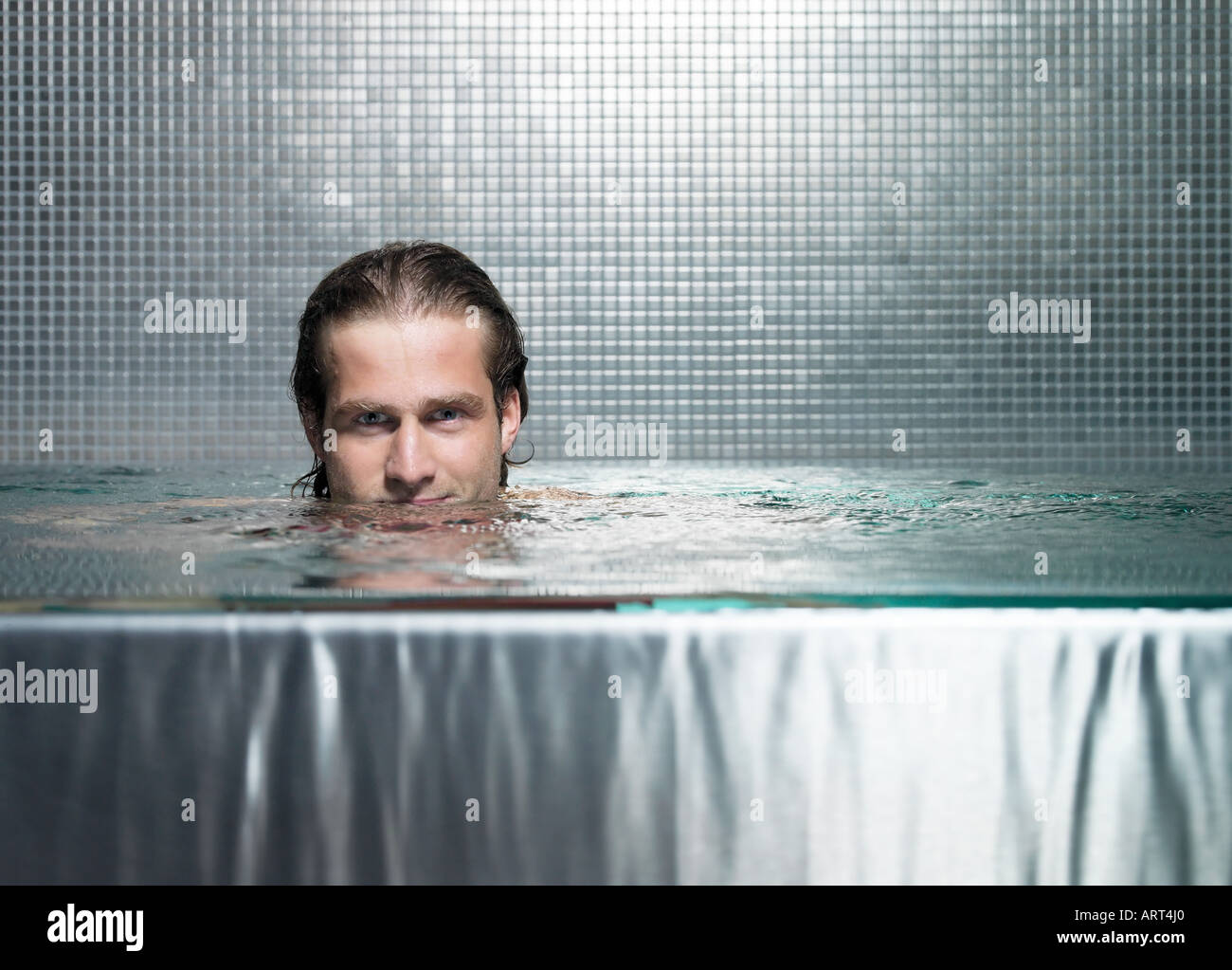 Man immersing in jacuzzi Stock Photo - Alamy