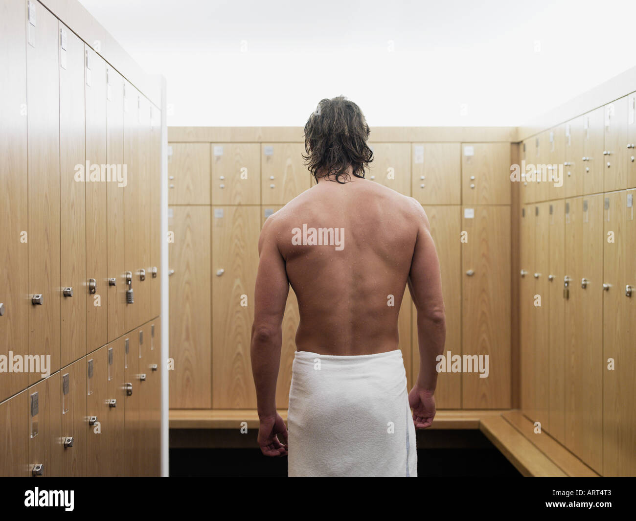 Man standing in locker room in gym Stock Photo - Alamy