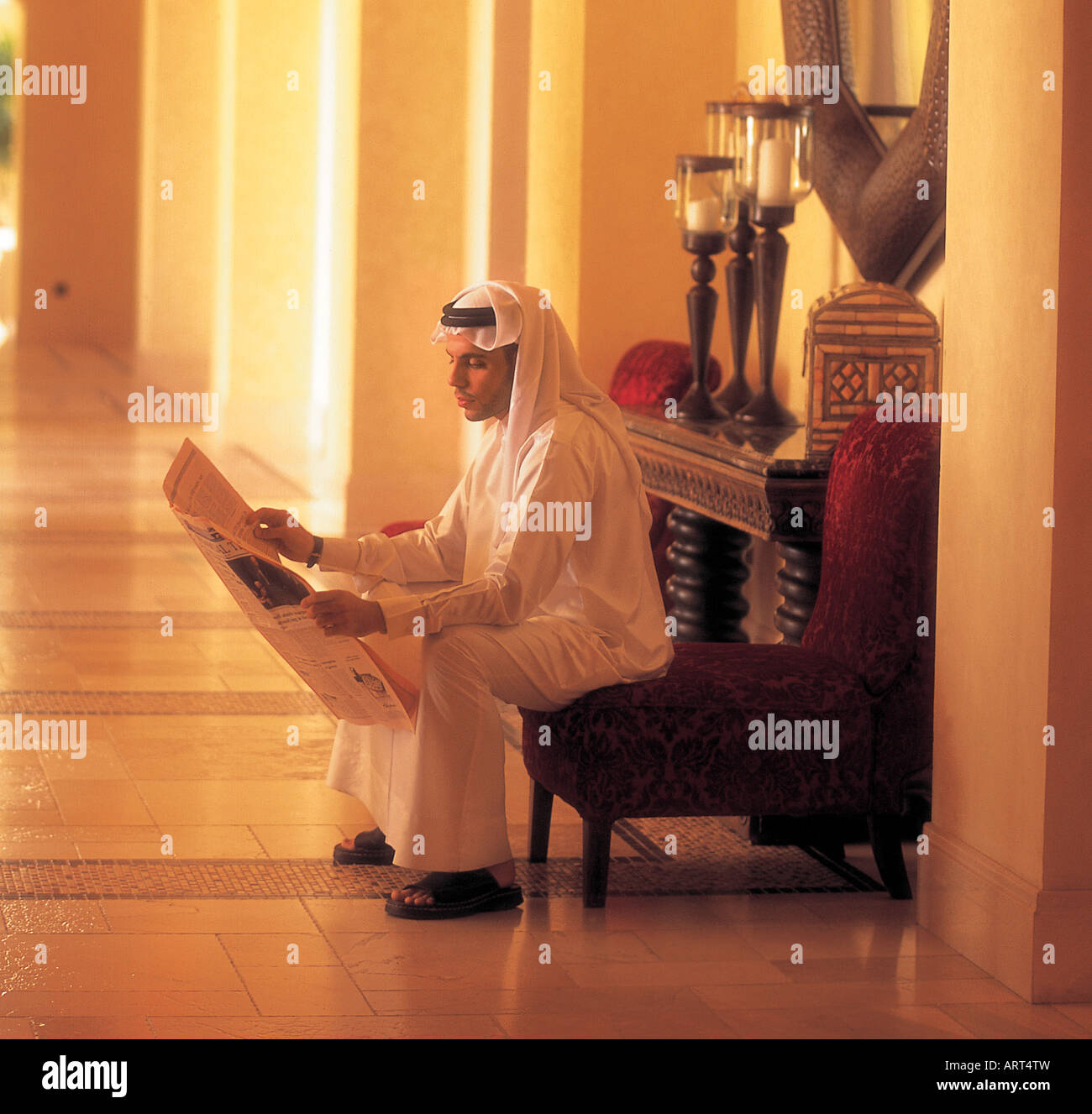 Arab businessman reading the newspaper Stock Photo - Alamy