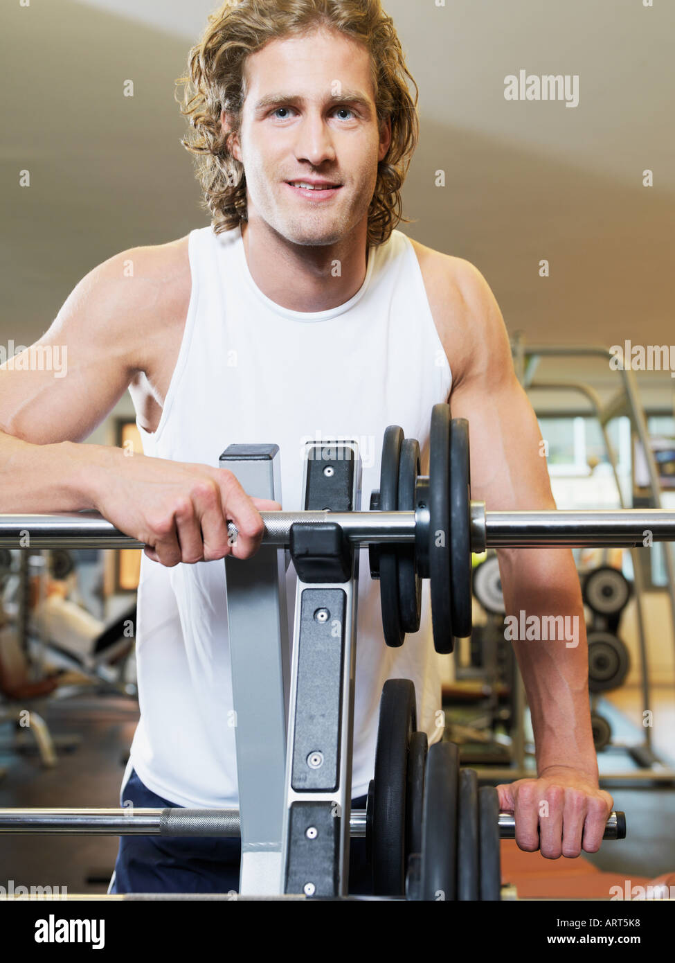 Man standing at exercising equipment Stock Photo - Alamy