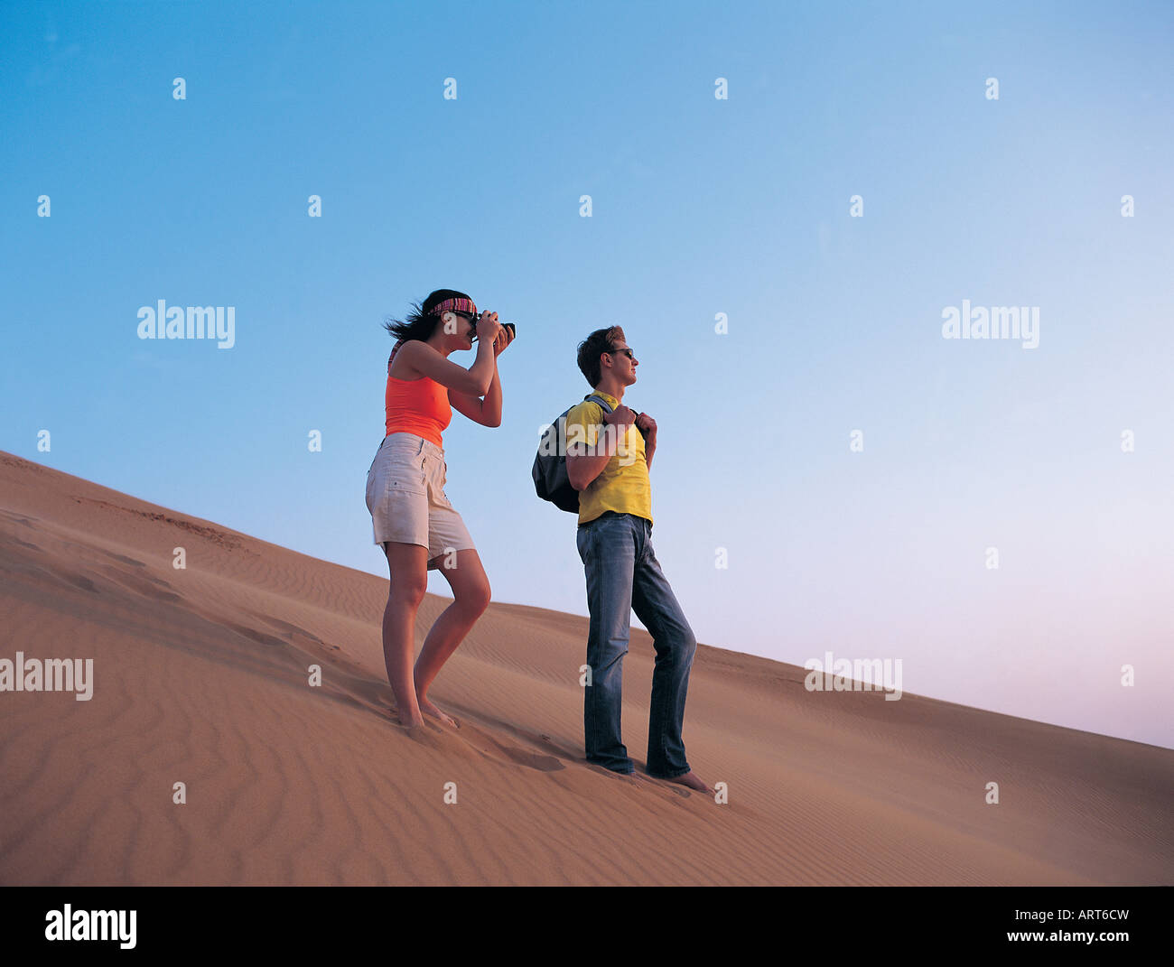 Western tourist taking pictures in the desert of the United Arab ...