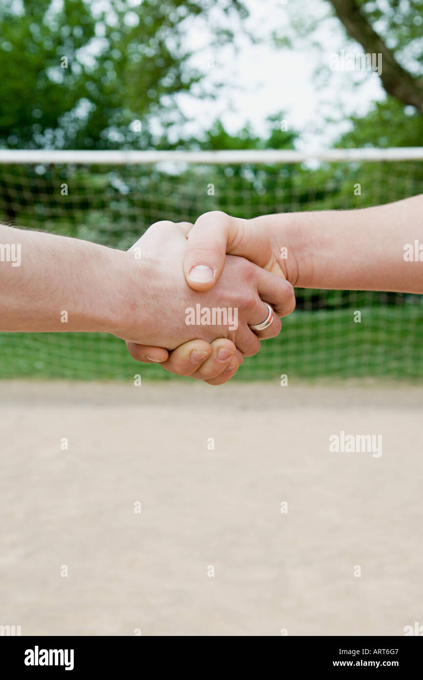 Footballers shaking hands Stock Photo - Alamy
