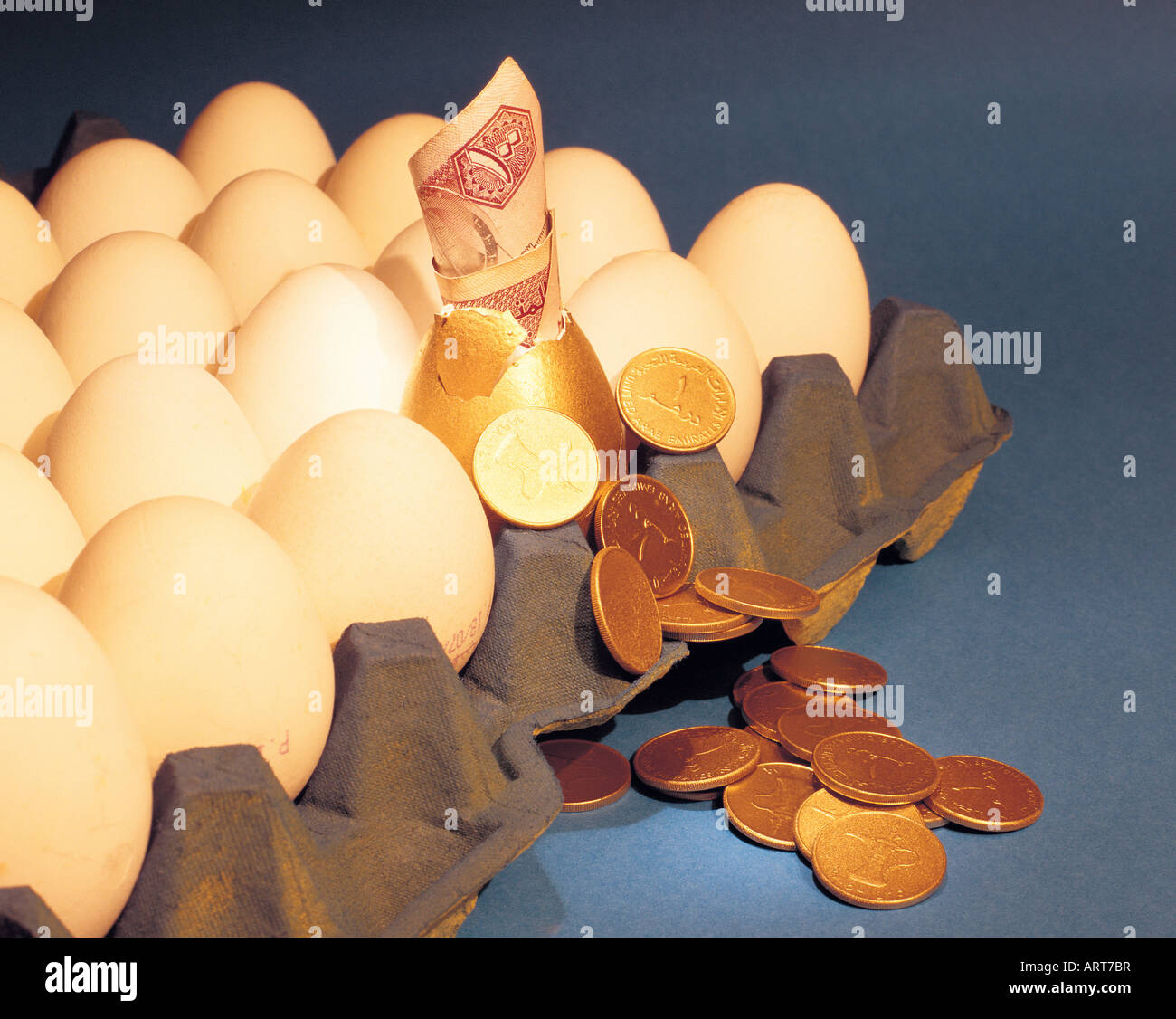 Money sticking out of a golden egg Stock Photo - Alamy
