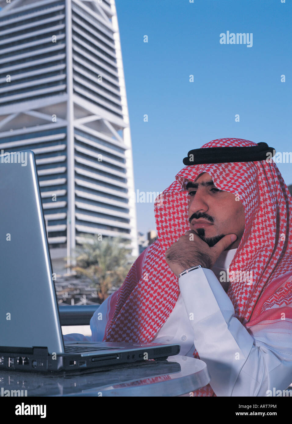 Saudi Businessman working on Laptop near Faisaliah Tower in Riyadh ...