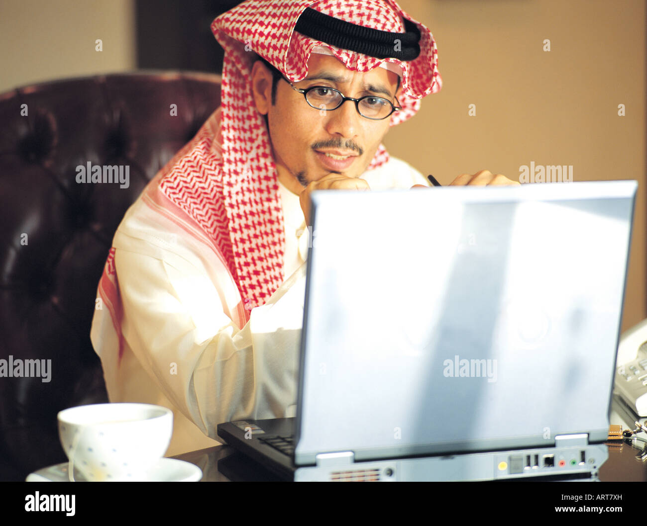 Saudi businessman working on laptop Stock Photo - Alamy