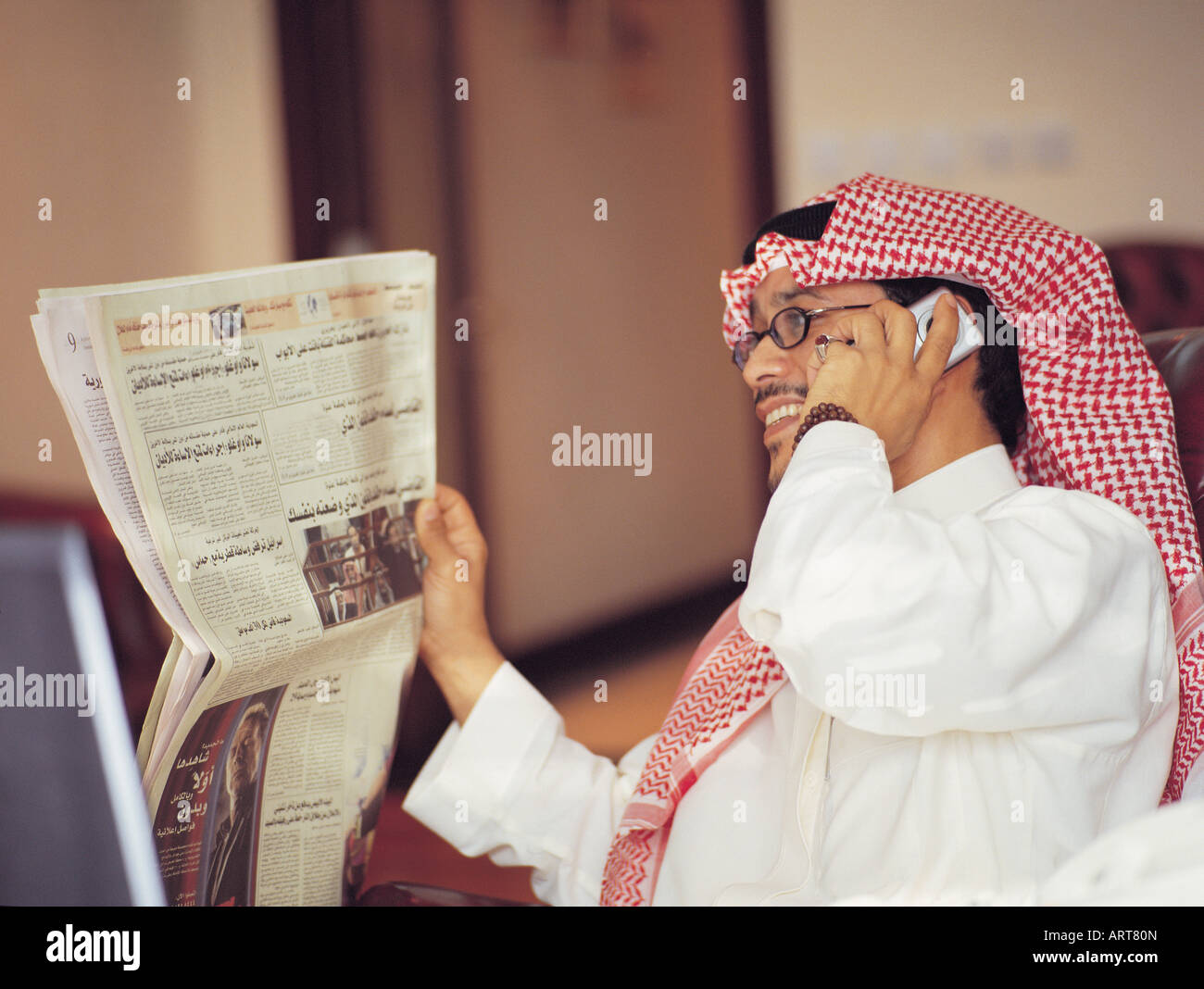 Middle eastern male reading newspaper hi-res stock photography and ...