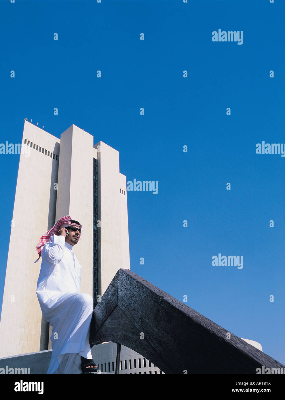 Saudi businessman using mobile phone in front of NCB building in Jeddah ...