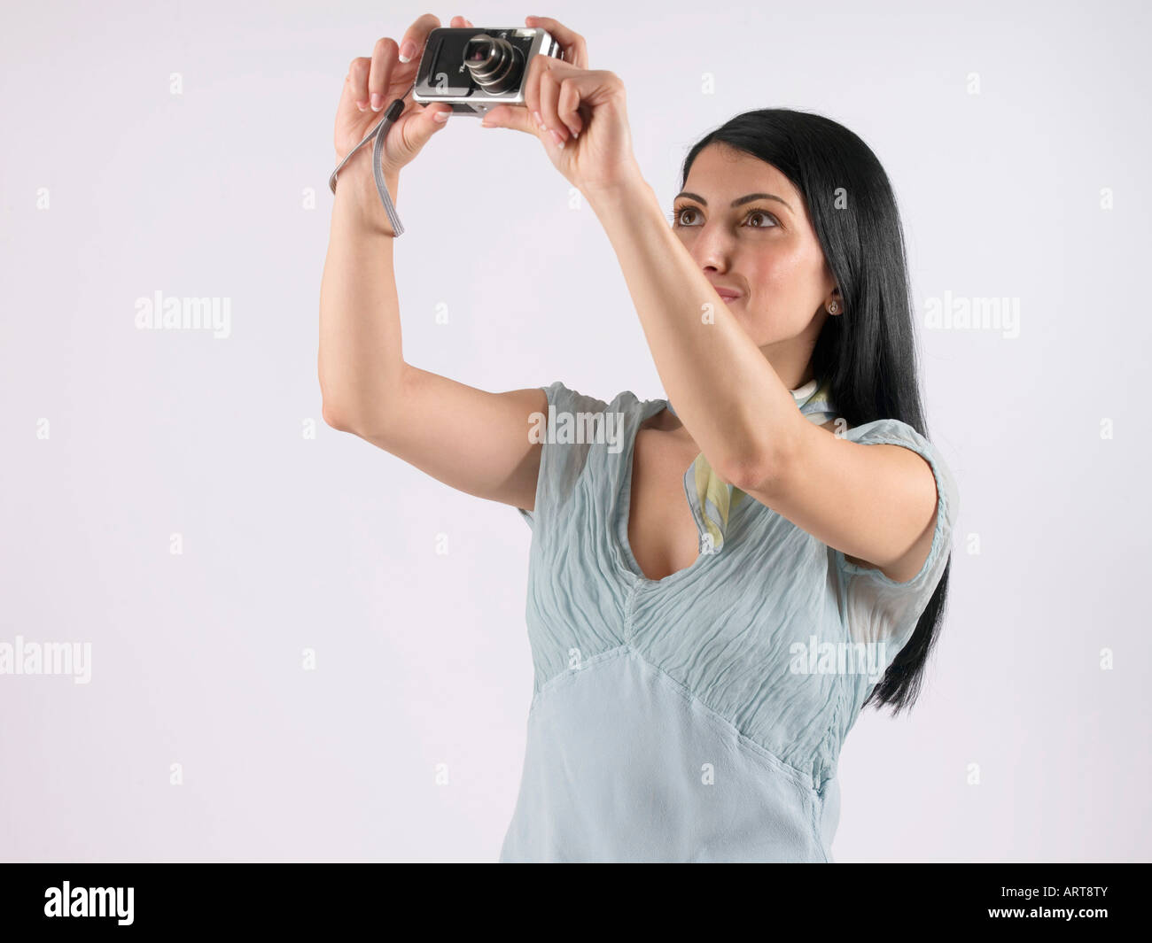 Woman holding up camera to take pictures Stock Photo - Alamy