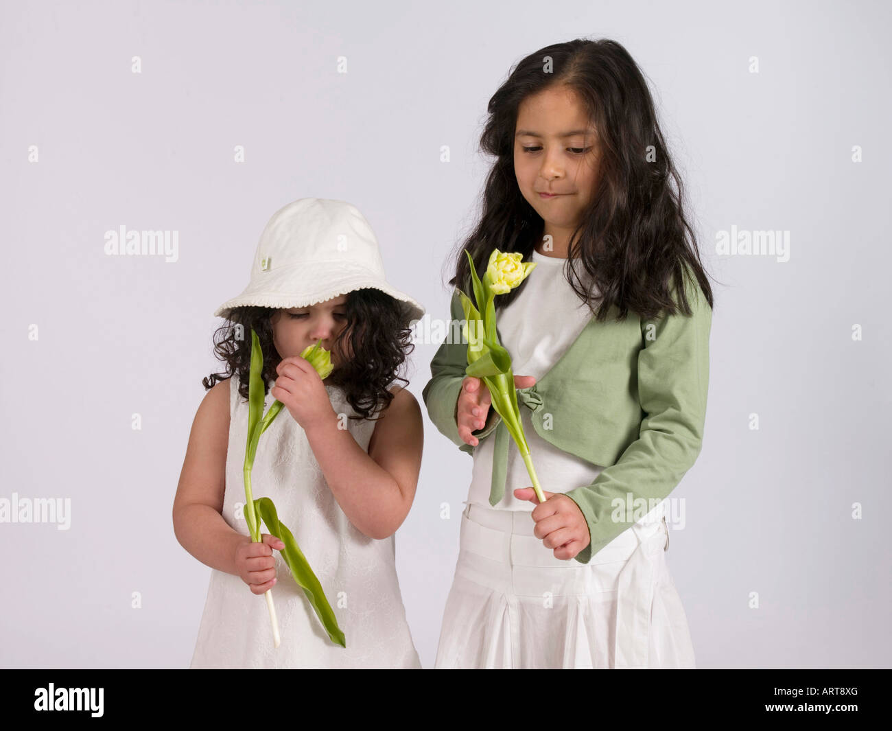 Two girls holding a flower Stock Photo - Alamy