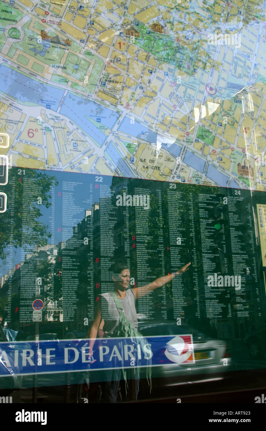 The refleciton of a woman waving for a taxi on the city tourism map of ...