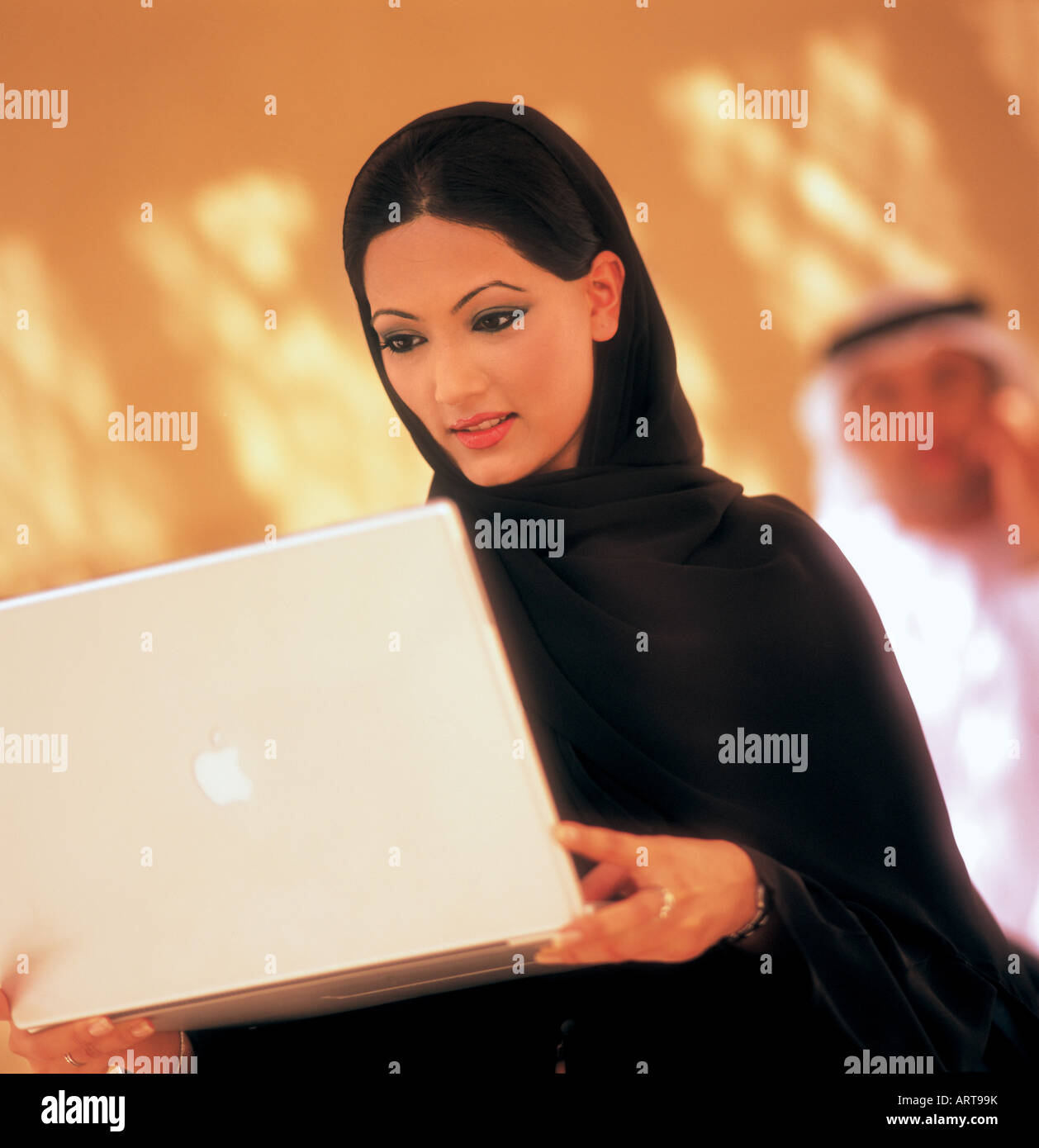 Arab woman using a laptop Stock Photo - Alamy