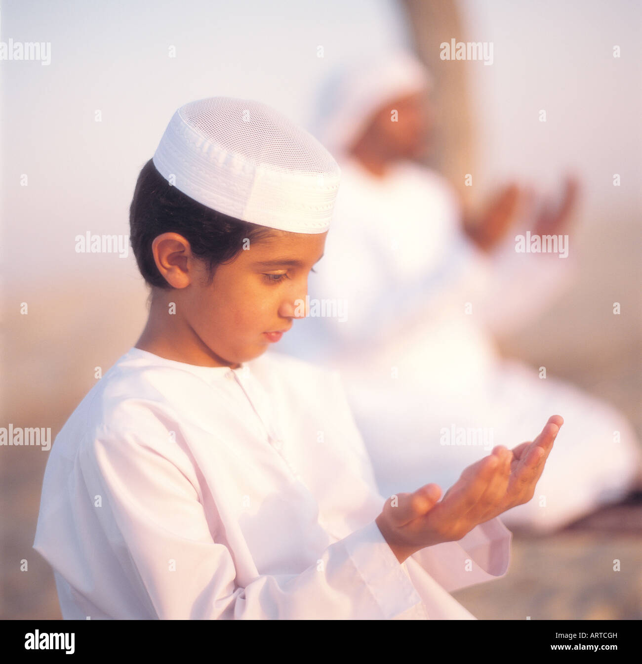Arab father and son during prayer (Dou'aa Stock Photo - Alamy