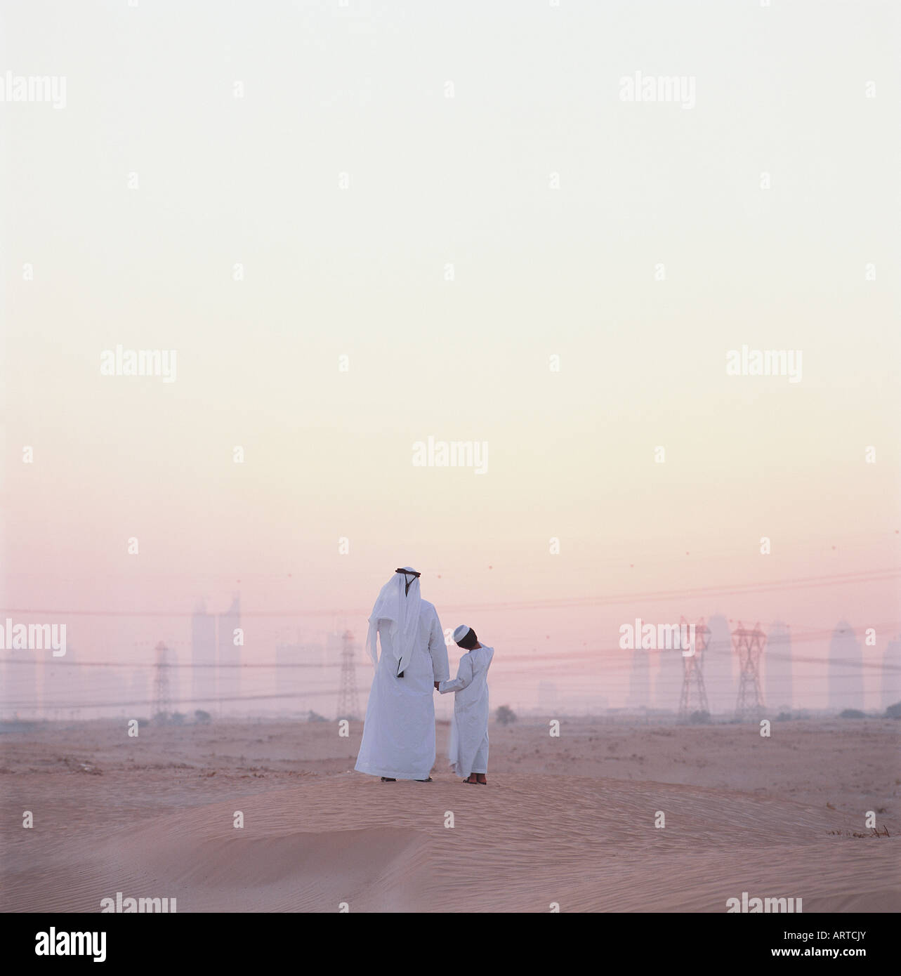 Emirati father and son looking out to skyline of Dubai, UAE Stock Photo ...