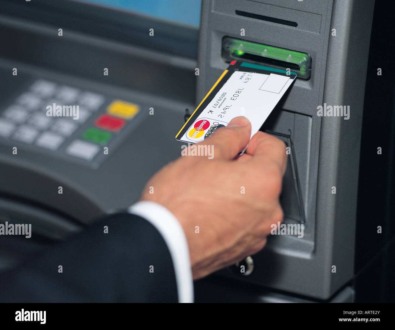Businessman using ATM Stock Photo - Alamy