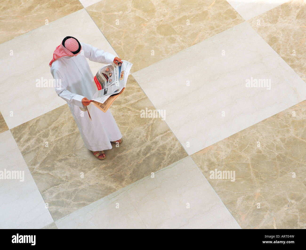 Arab man reading newspaper Stock Photo - Alamy