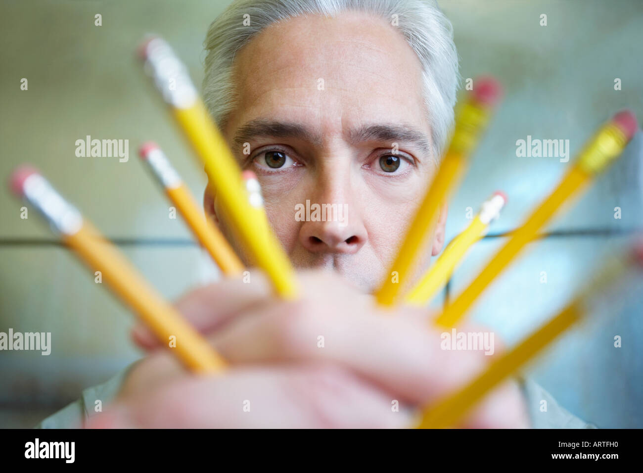 Man holding pencils Stock Photo - Alamy