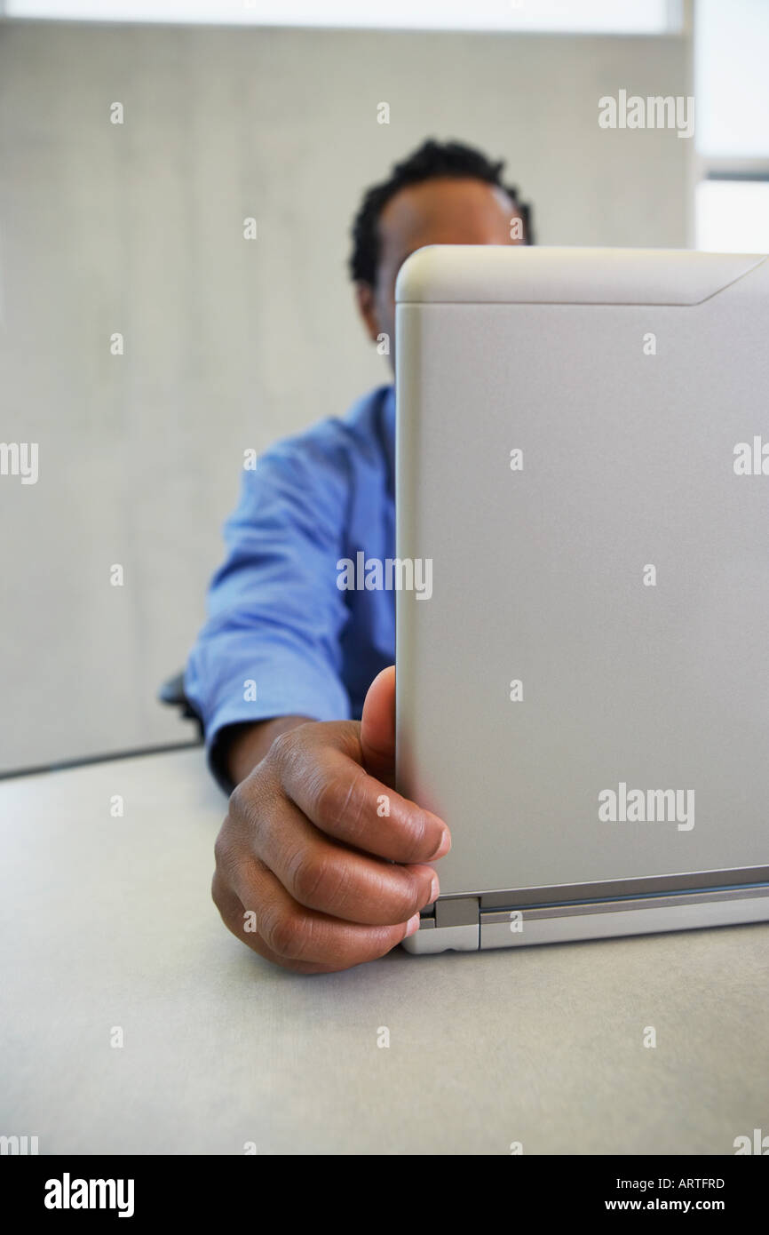Man behind laptop Stock Photo - Alamy