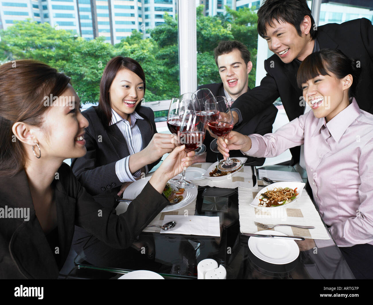 Businesspeople Toasting over Dinner Stock Photo - Alamy