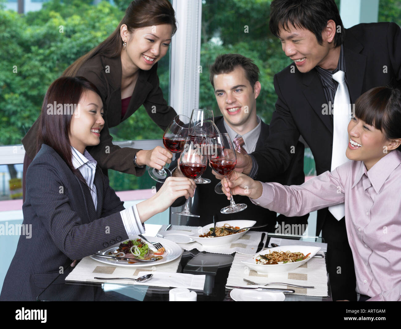 Businesspeople Toasting over Dinner Stock Photo - Alamy