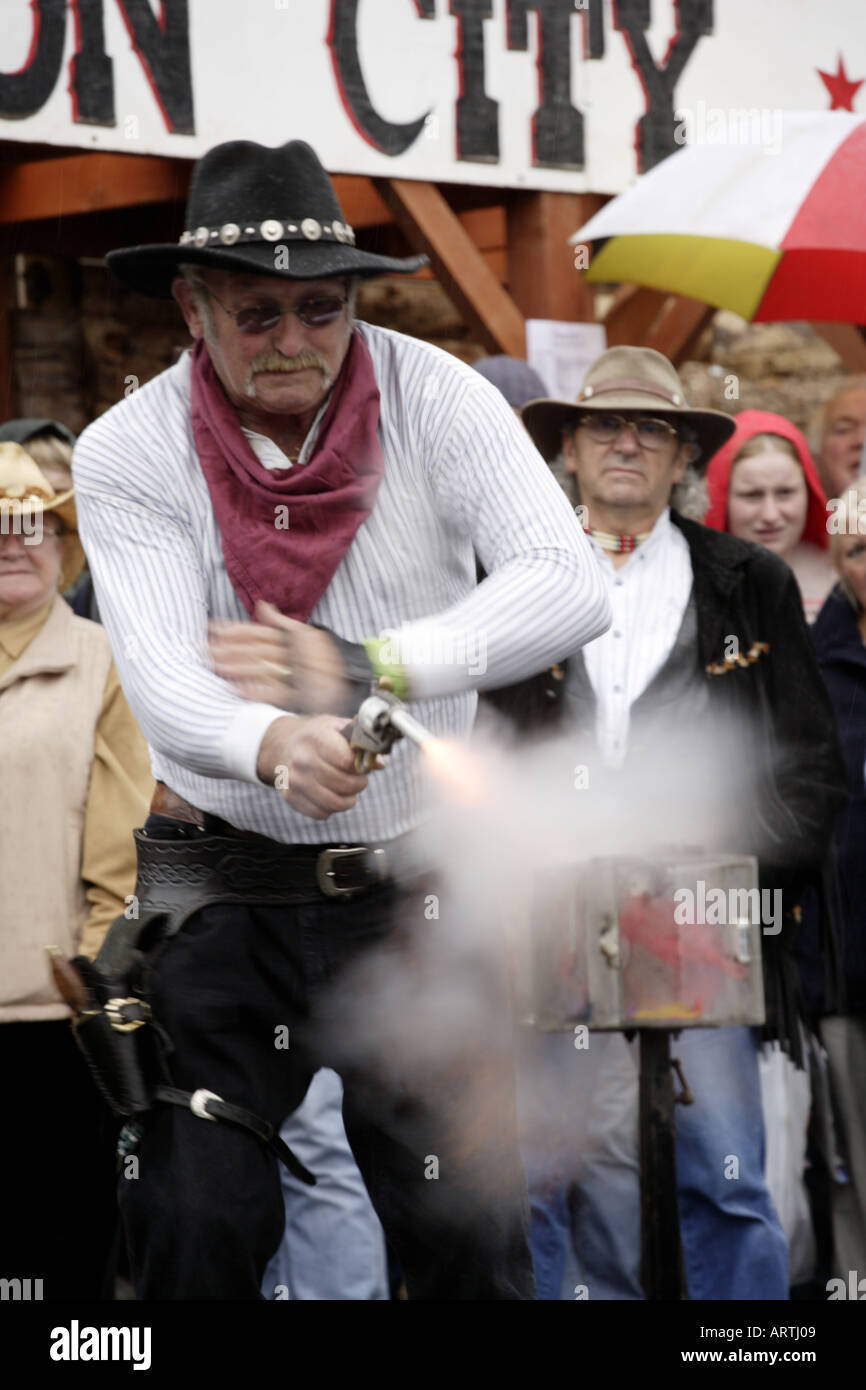 Cowboy firing gun Stock Photo - Alamy