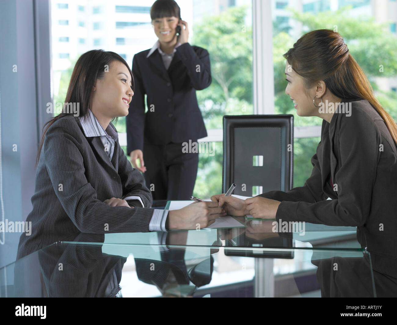 Three Business Women in a Conference Room Stock Photo - Alamy