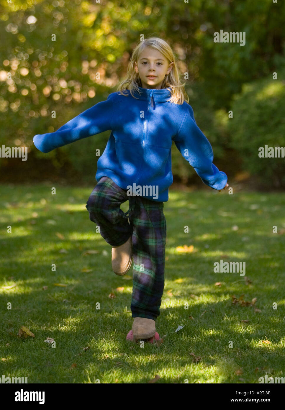 Young girl trying to keep her balance Stock Photo - Alamy