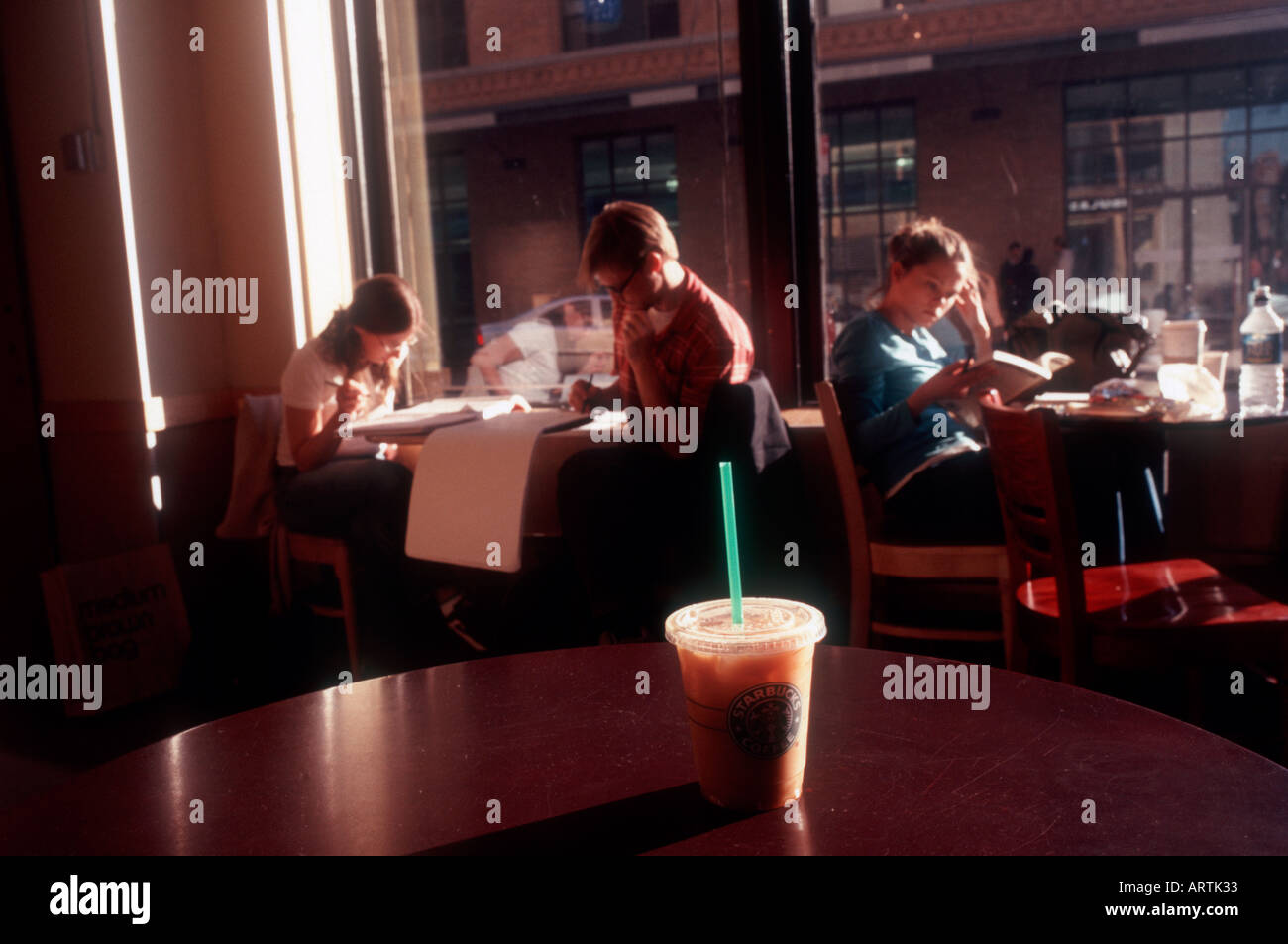 Customers read and work at a Starbucks coffee shop Stock Photo - Alamy