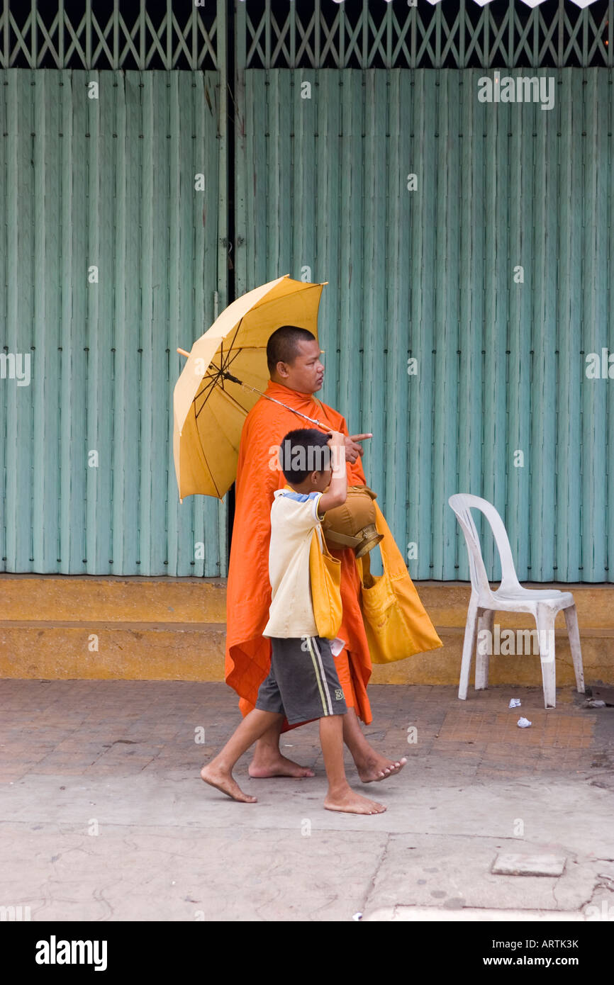 Monk with umbrella walking with boy Phnom Penh Cambodia Stock Photo - Alamy
