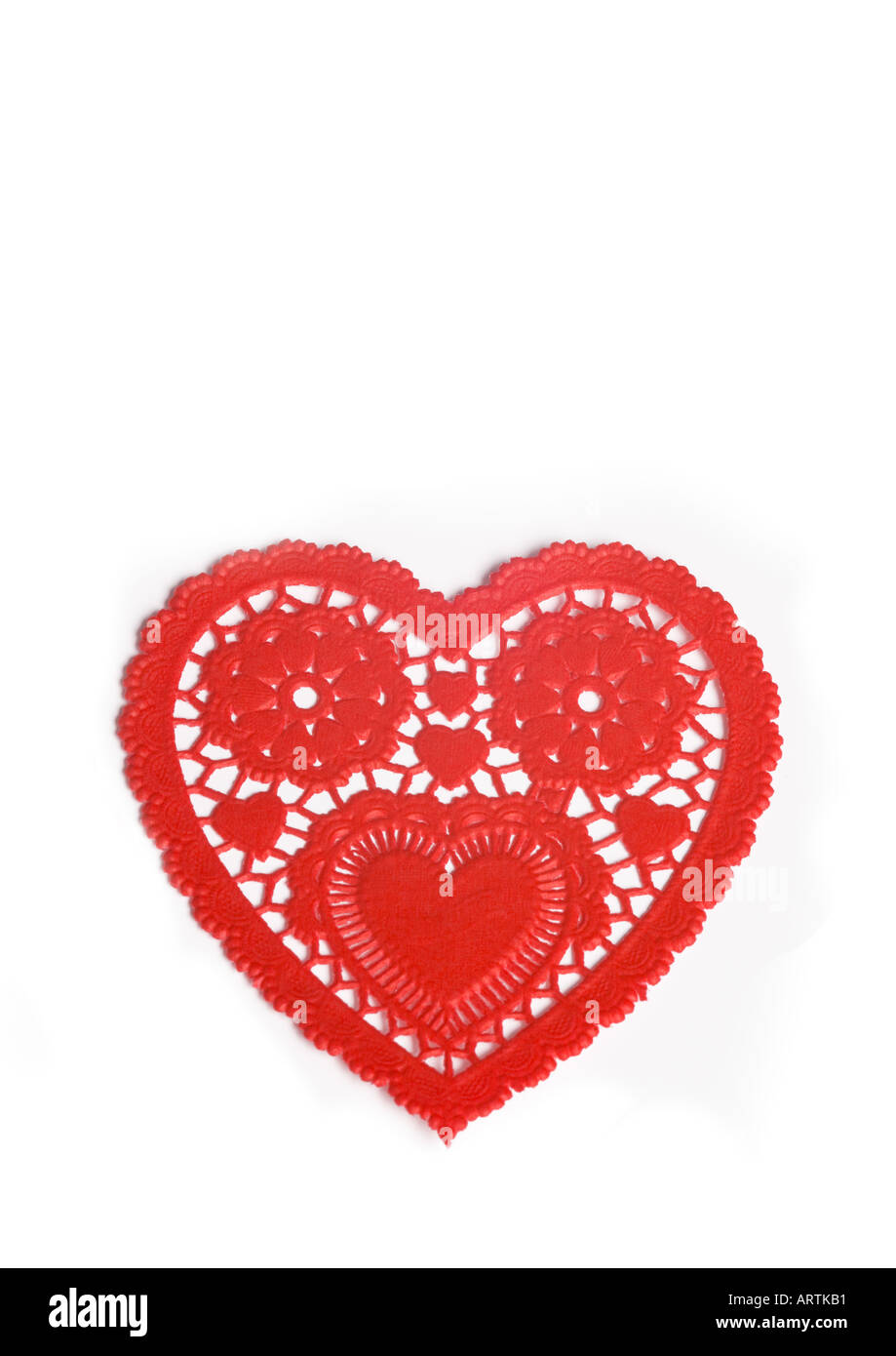 Red cut out valentine heart doily on white background Stock Photo - Alamy