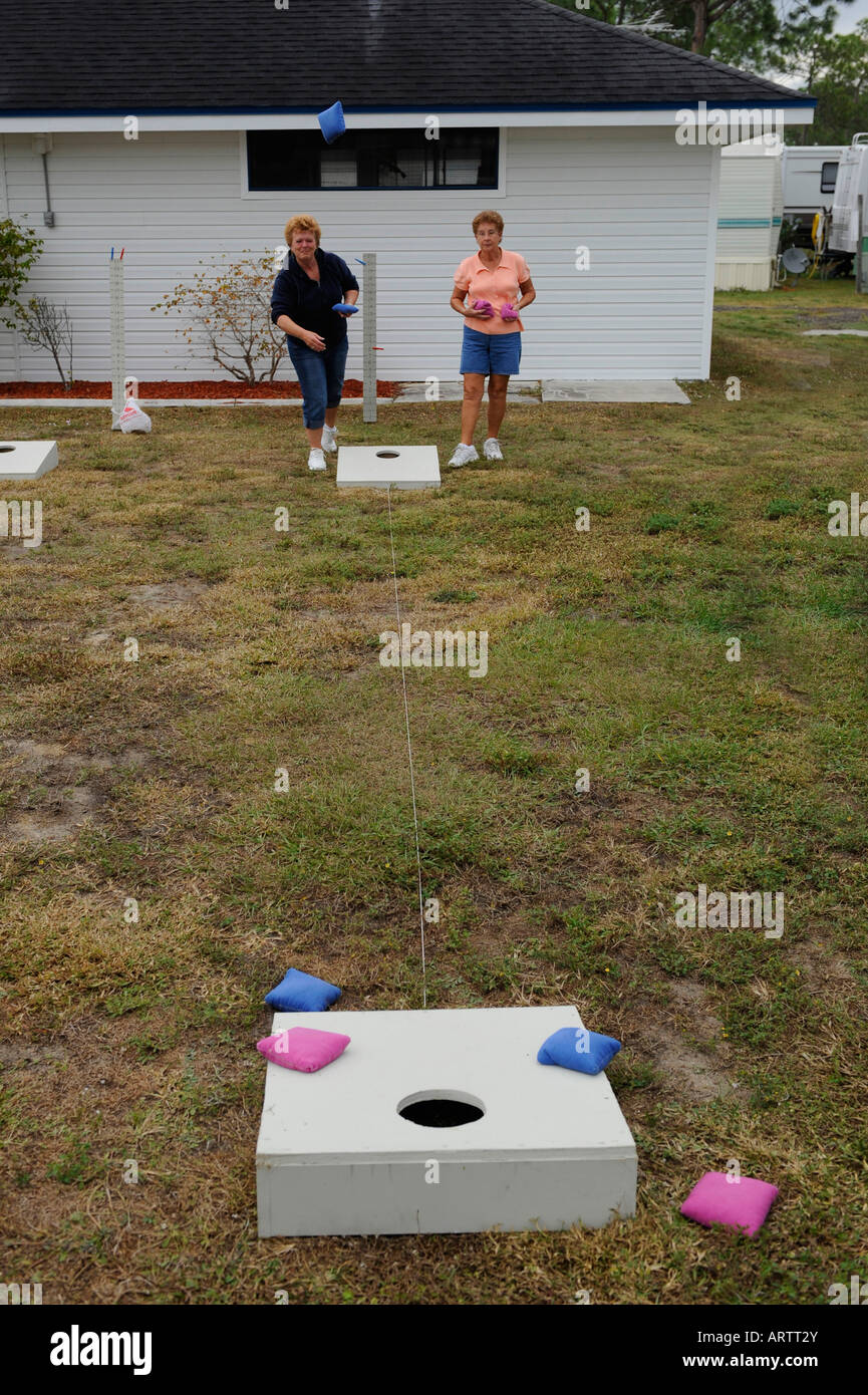 Senior Retired Citizens Play Game Of Bean Bag Toss In A Recreational Vechile Camping Park In