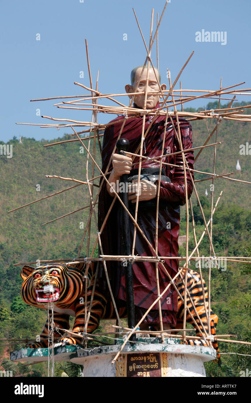 Statue of Buddhist monk with a tiger (with bamboo scaffolding), Yadana ...