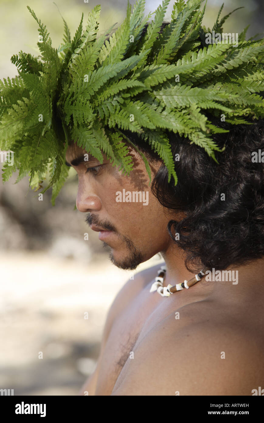 Male (kane) hula dancer deep in thought, wearing palapalai fern head ...