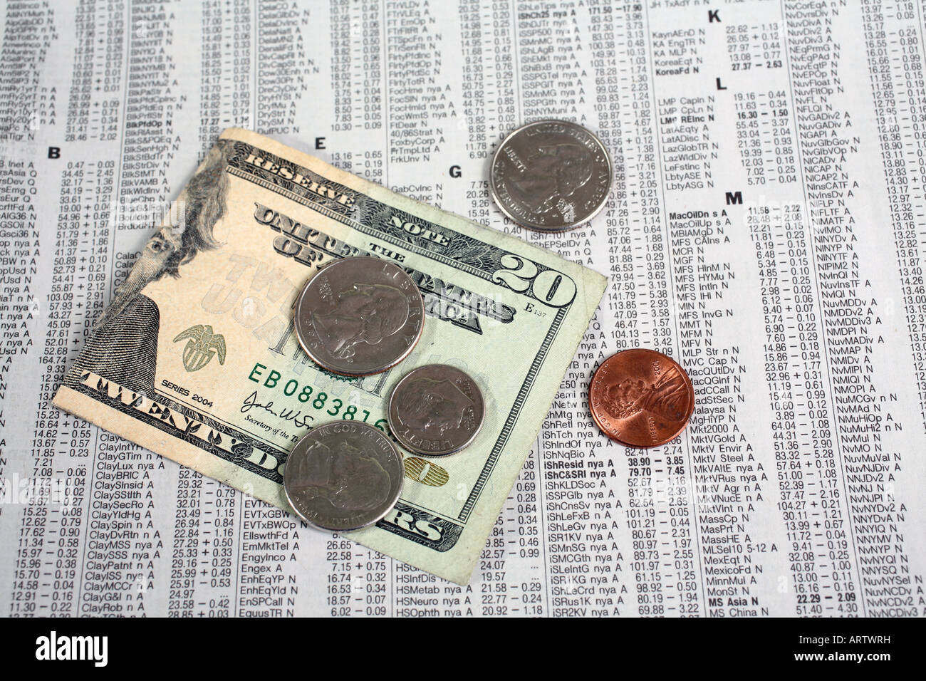 Twenty dollar bill and coins on stock financial page Stock Photo - Alamy