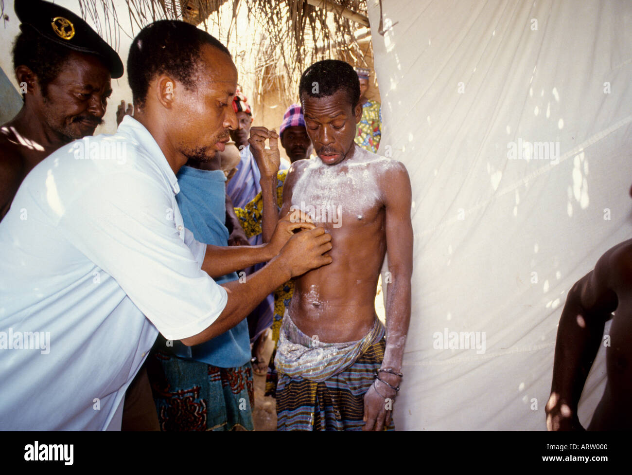 An assistant of the healer makes seven light incisions in his chest ...