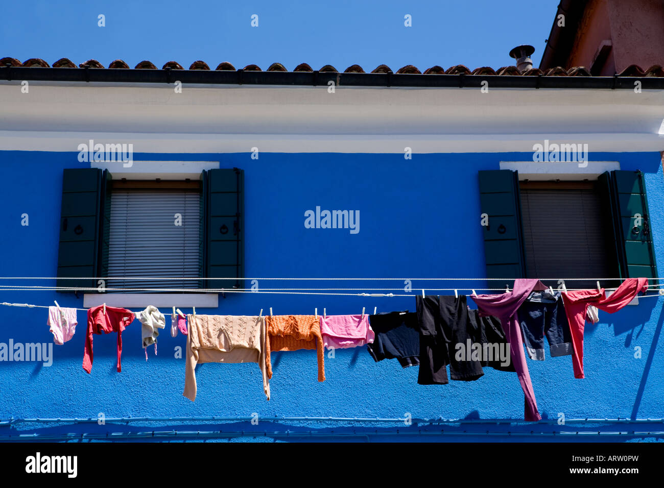 The day's laundry hangs on the wash line to dry in Burano Italy Stock ...