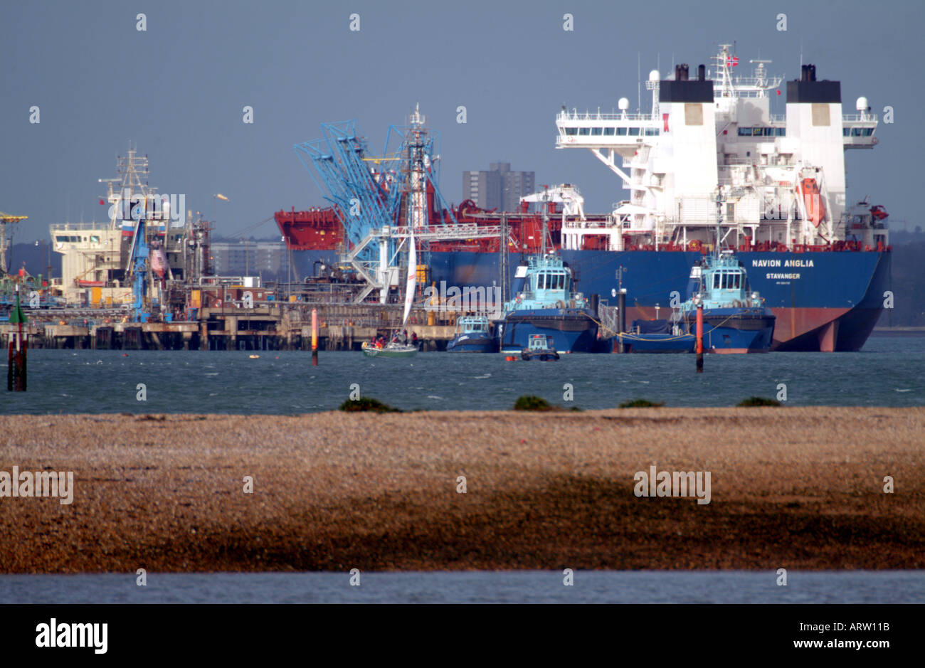 Oil tanker Navion Anglia with berthing tugs at Fawley Terminal ...