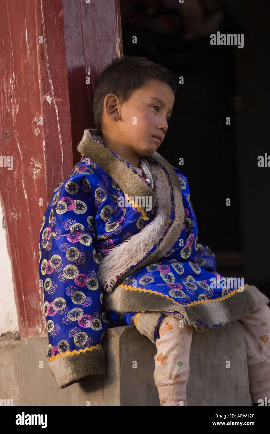 Boy wearing traditional Tibetan coat, Langmusi, Gansu, China Stock ...