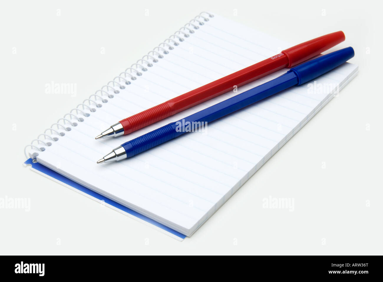 Two writing pens on notepad, stationery Stock Photo - Alamy