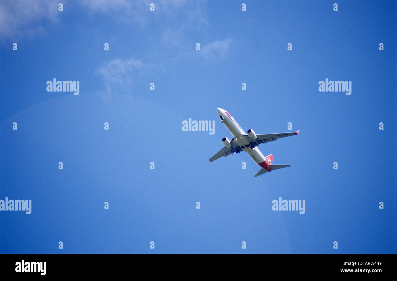 Commercial airplane flying overhead against blue sky taking off Stock ...