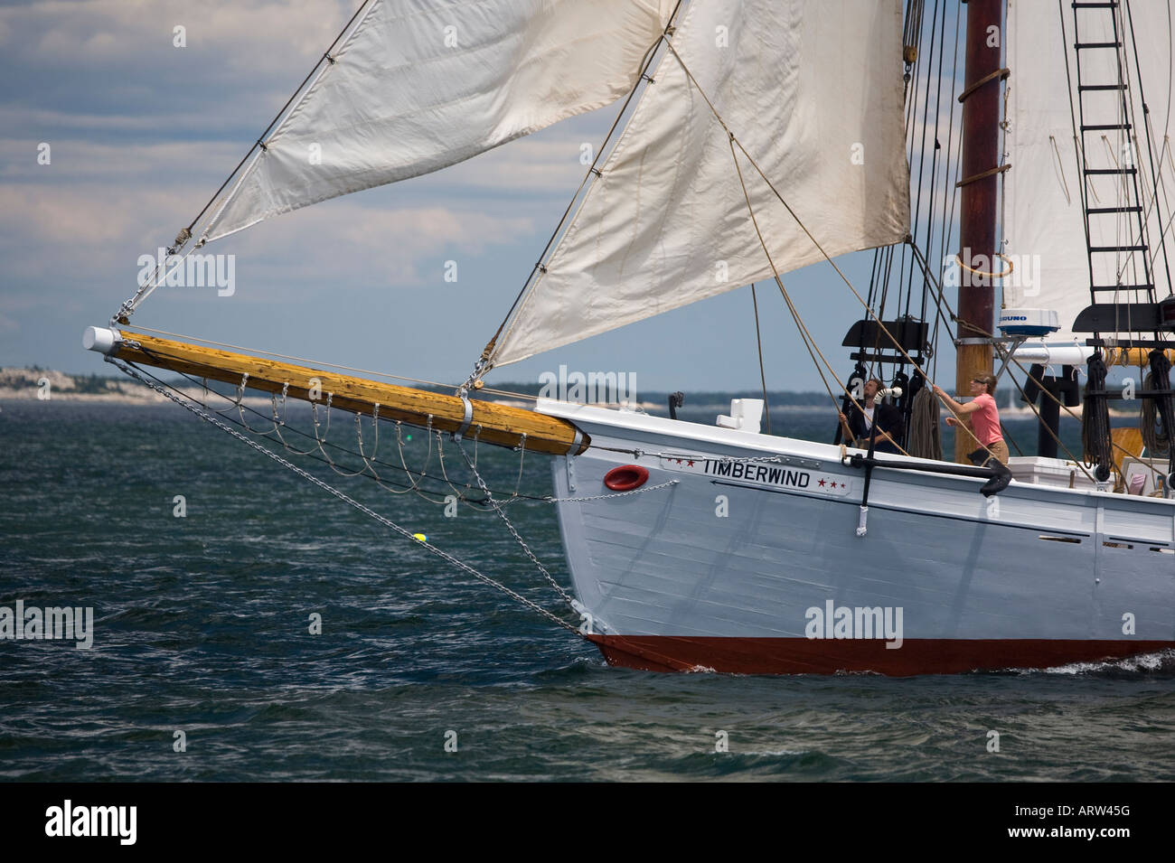 Two crew members help tack the two masted schooner Timberwind during a ...