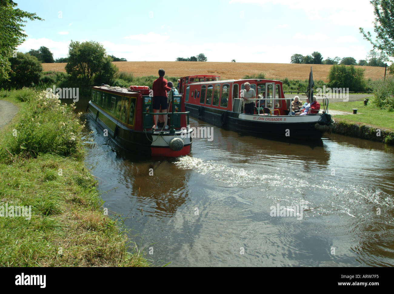Two narrow boats passing on the Union canal in West Lothian Scotland ...