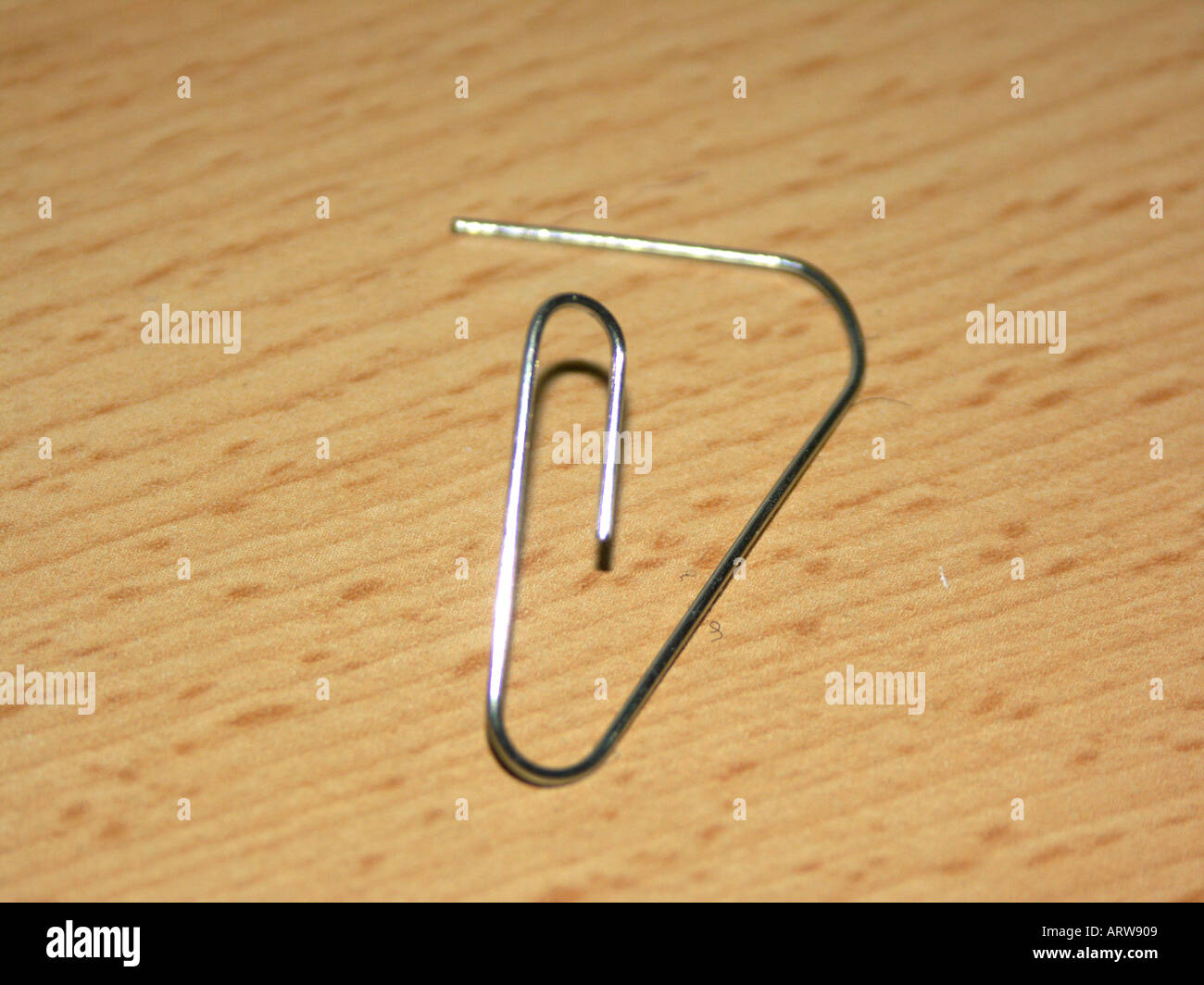 Bent Paperclip on Desk Stock Photo - Alamy