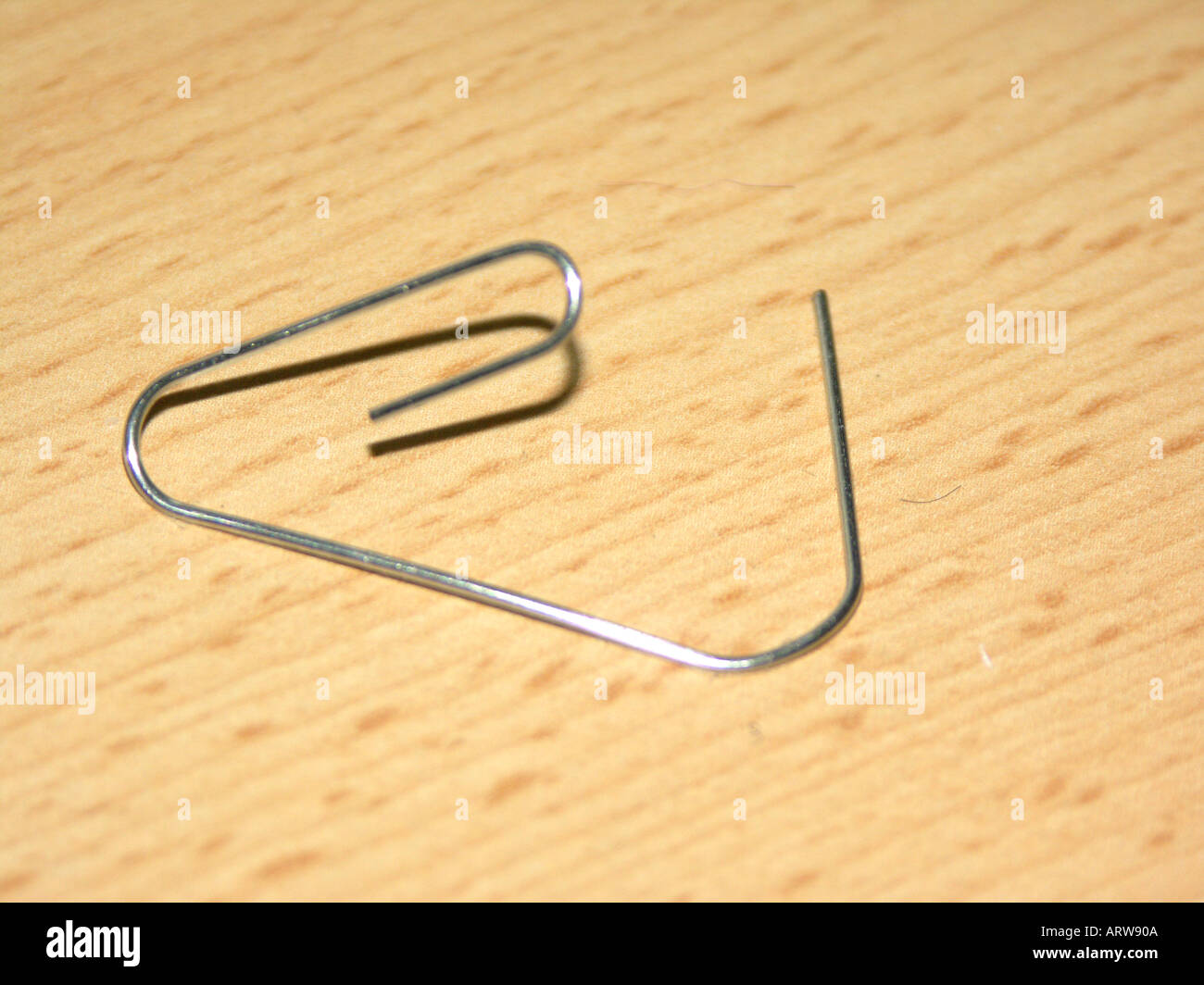 Bent Paperclip on Desk Stock Photo - Alamy