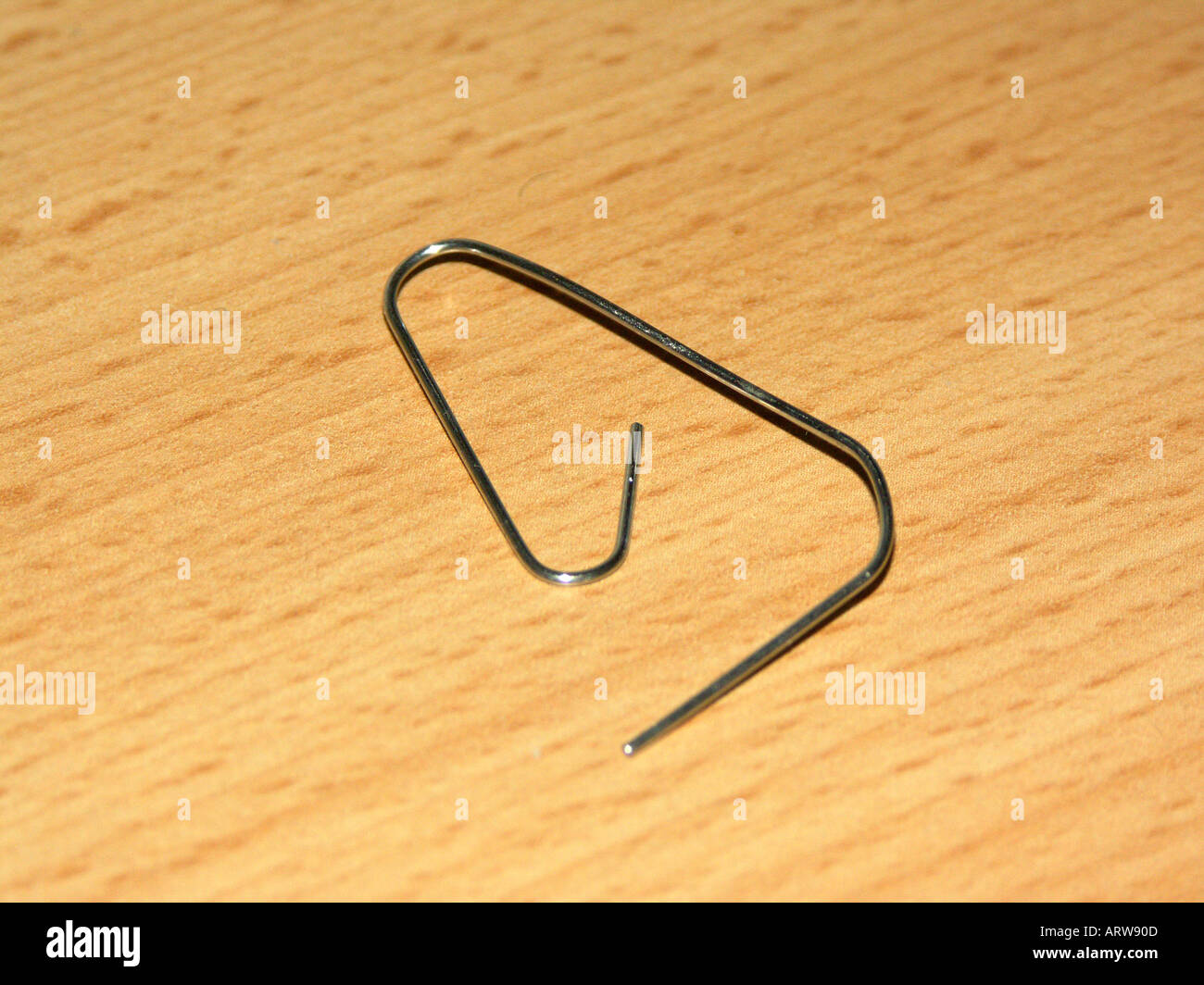 Bent Paperclip on Desk Stock Photo - Alamy