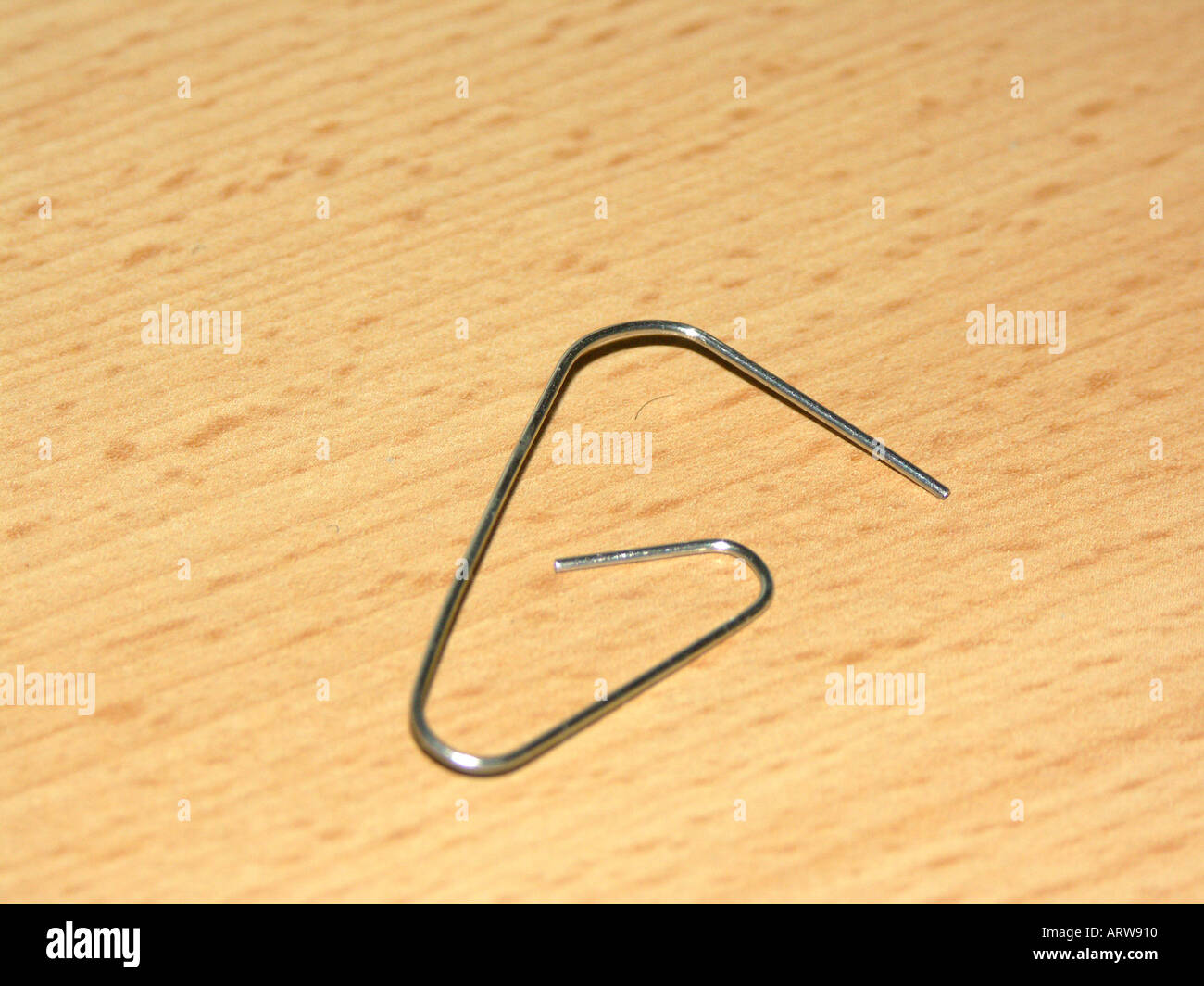 Bent Paperclip on Desk Stock Photo - Alamy